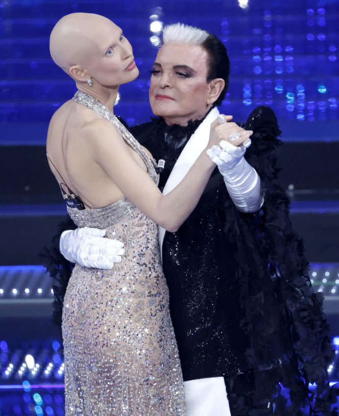 Sanremo 2025, Cristiano Malgioglio sfida Bianca Balti con un look da ...